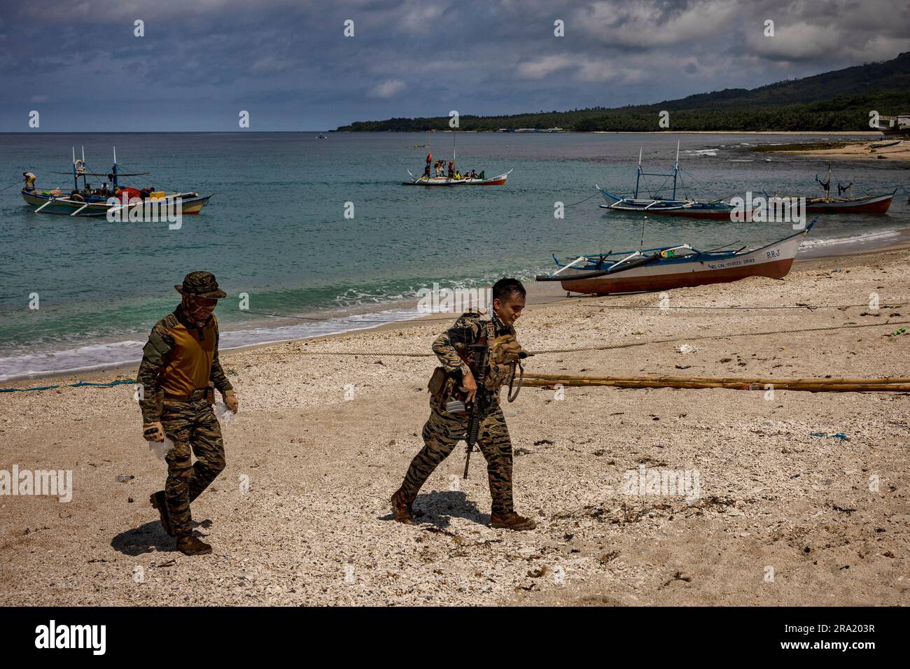 Filipino soldiers walk along a beach Friday, June 30, 2023, in Calayan ...