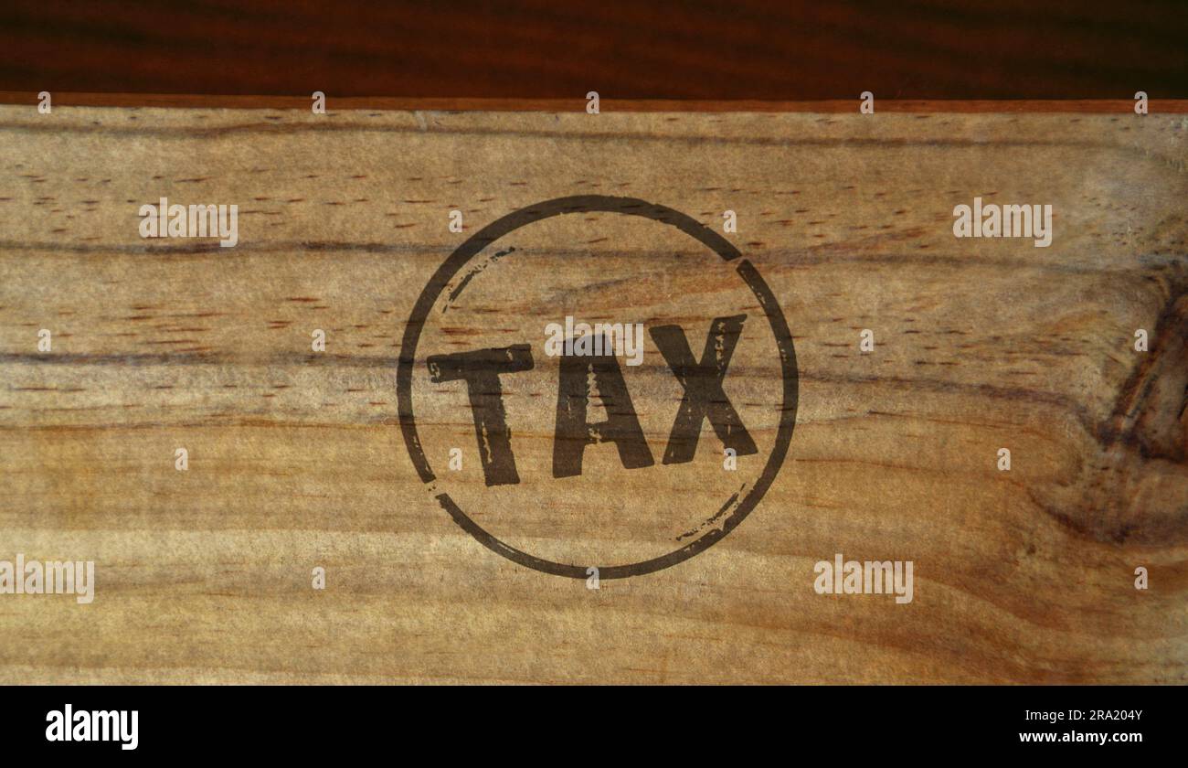 Tax stamp printed on wooden box. Income taxation and payment concept ...