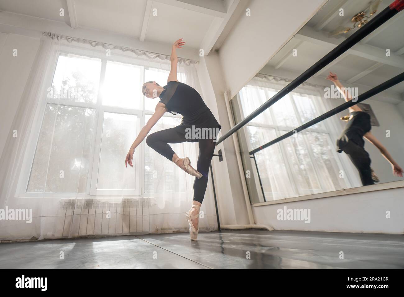 A beautiful Asian woman is dancing at the barre. Ballet dancer Stock ...