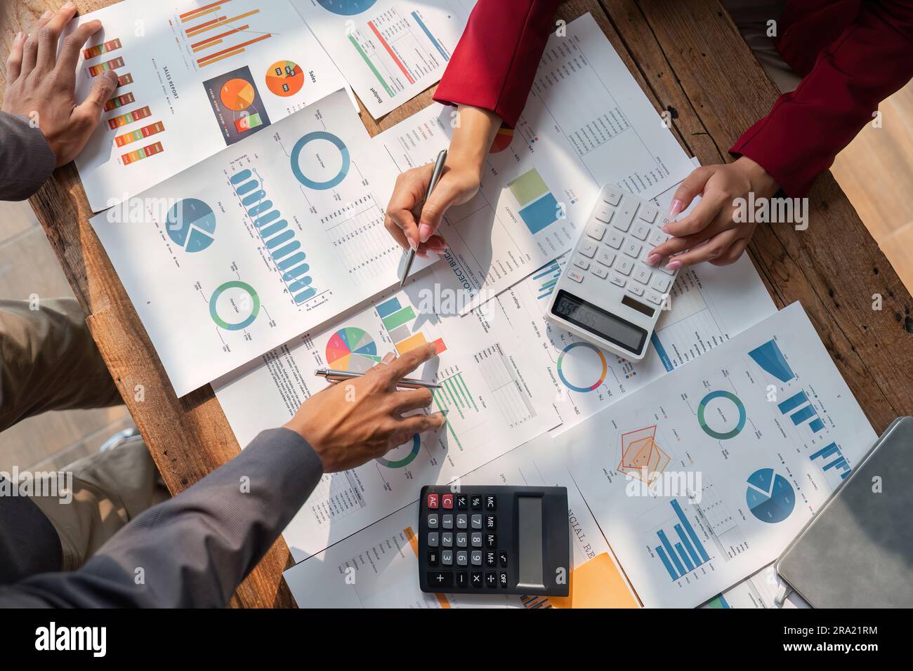 Business people brainstorming at office desk analyzing financial ...