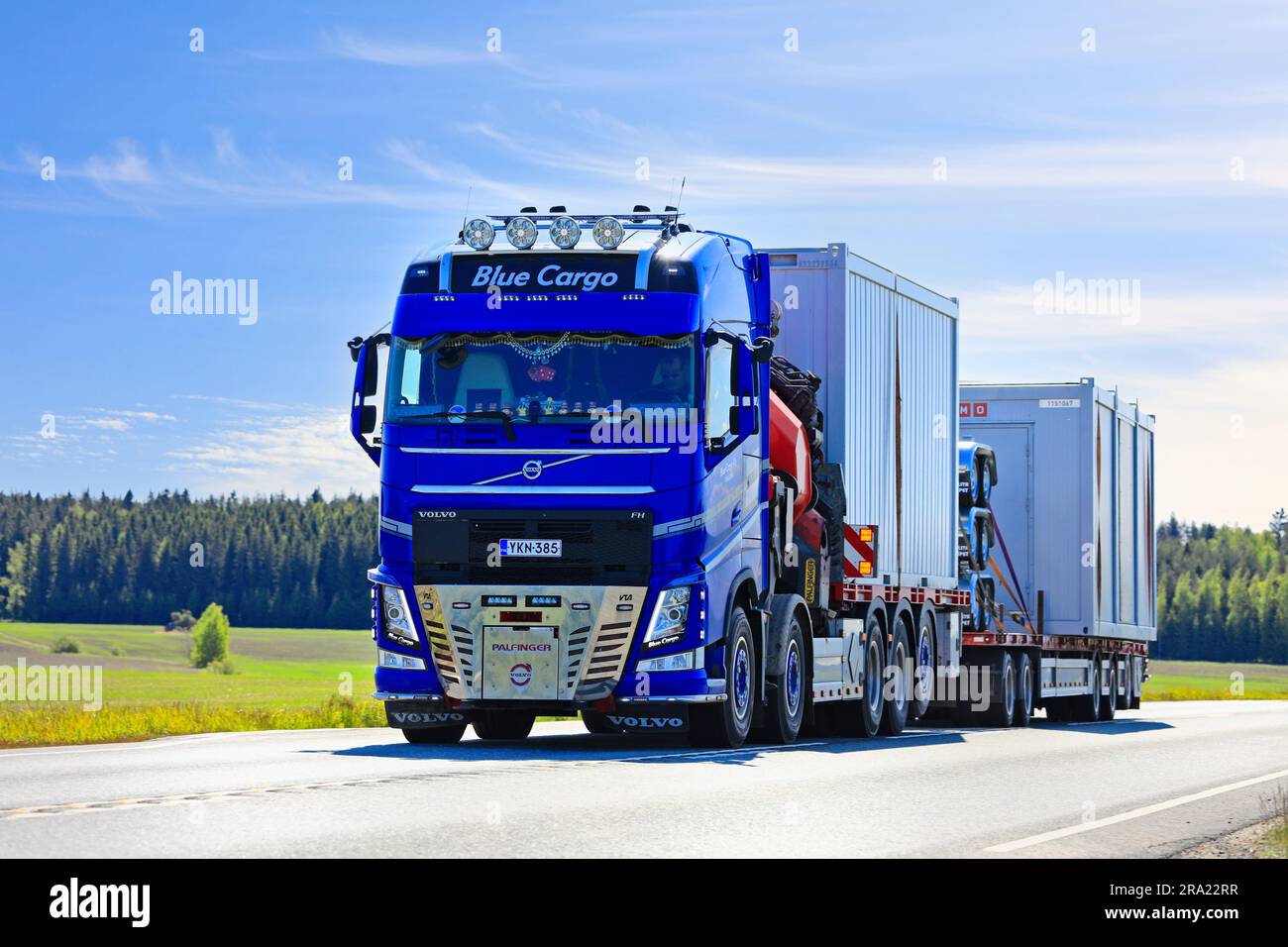 Blue Volvo FH16 truck with Palfinger crane of Blue Cargo Oy pulls two ...