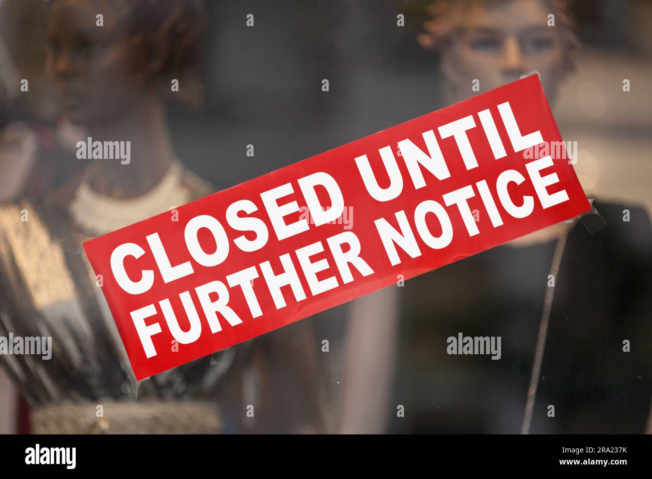 Red sign in a window shop saying "Closed until further notice Stock ...