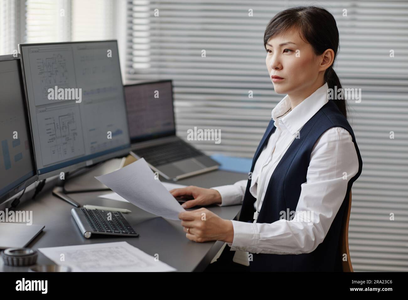 Side view portrait of Asian woman as female engineer using computer ...