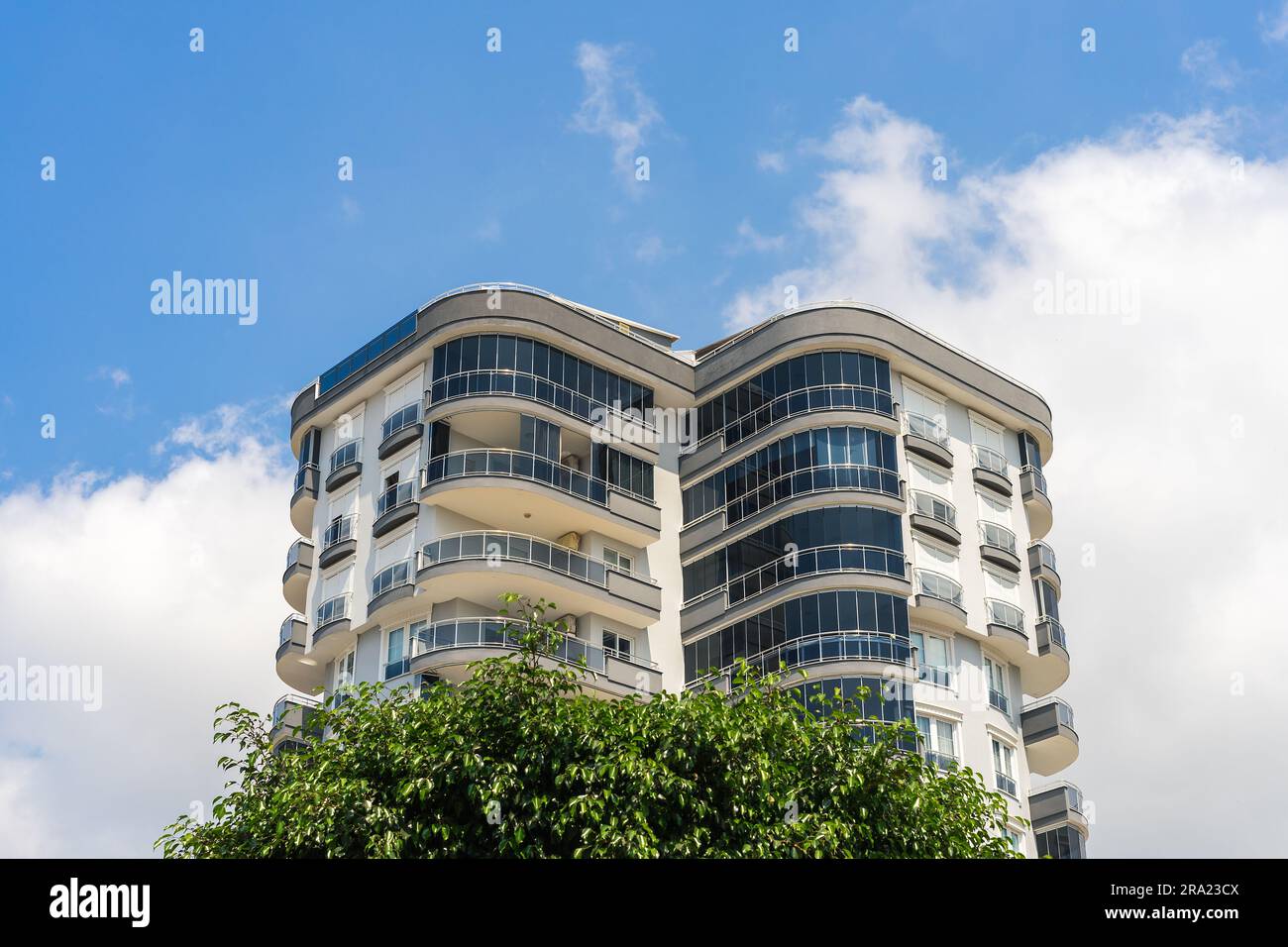 Exterior of a high-rise apartment building. Large balconies. Sunny day ...