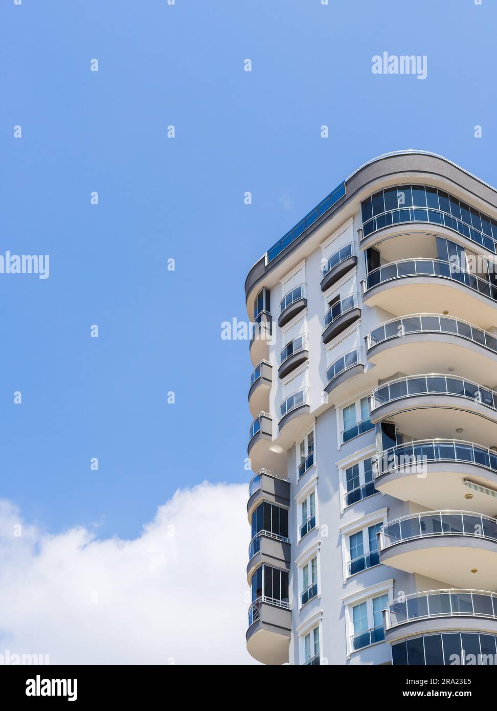 Exterior of a high-rise apartment building. Large balconies. Sunny day ...