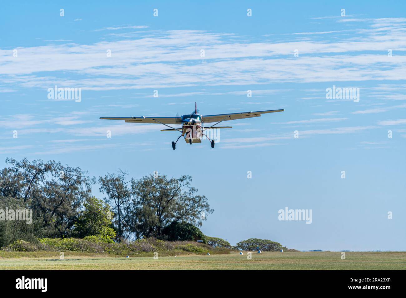 Cessna Caravan 208 Sea Air flying landing on grass runway on Lady ...