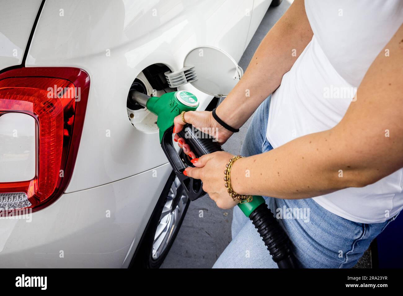 HELMOND - A woman fills up her car at a Tango gas station in Helmond ...
