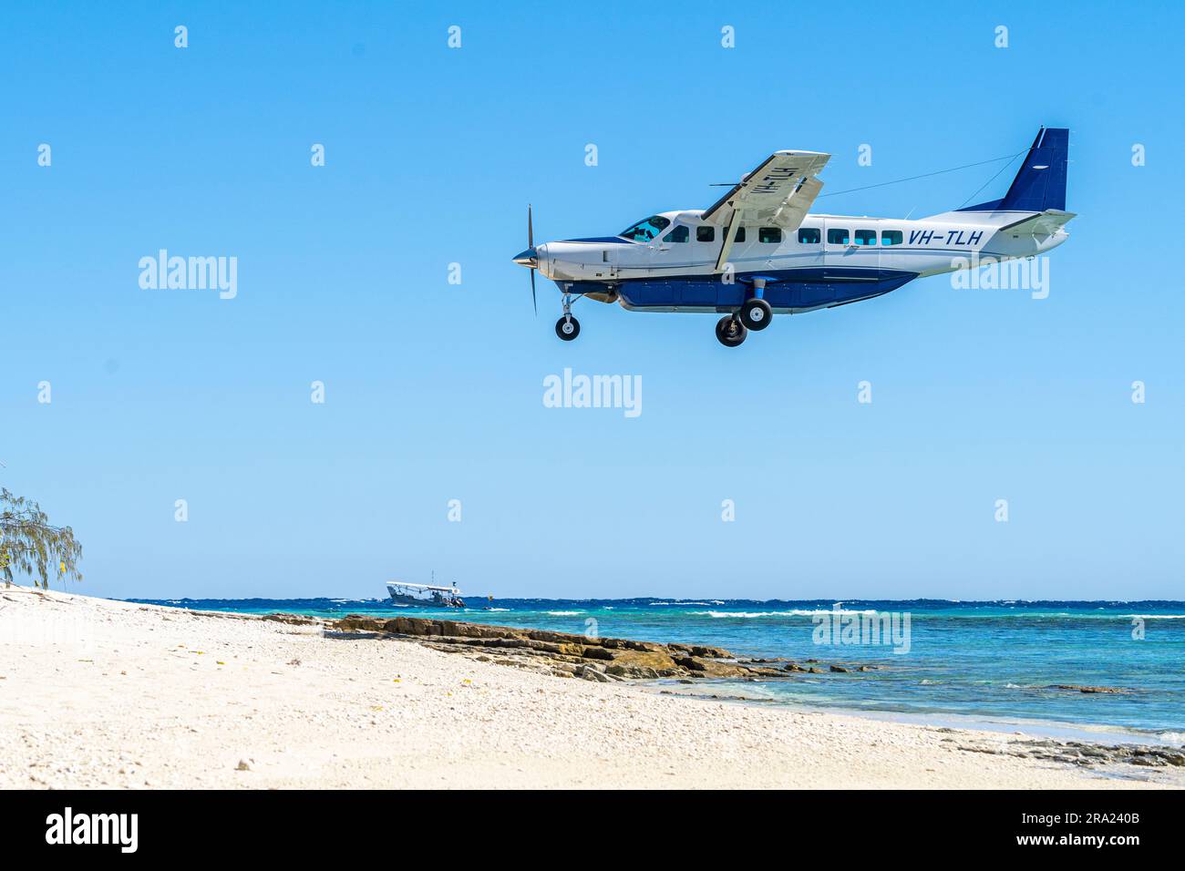 Cessna Caravan 208 Sea Air flying over beach on landing approach to ...
