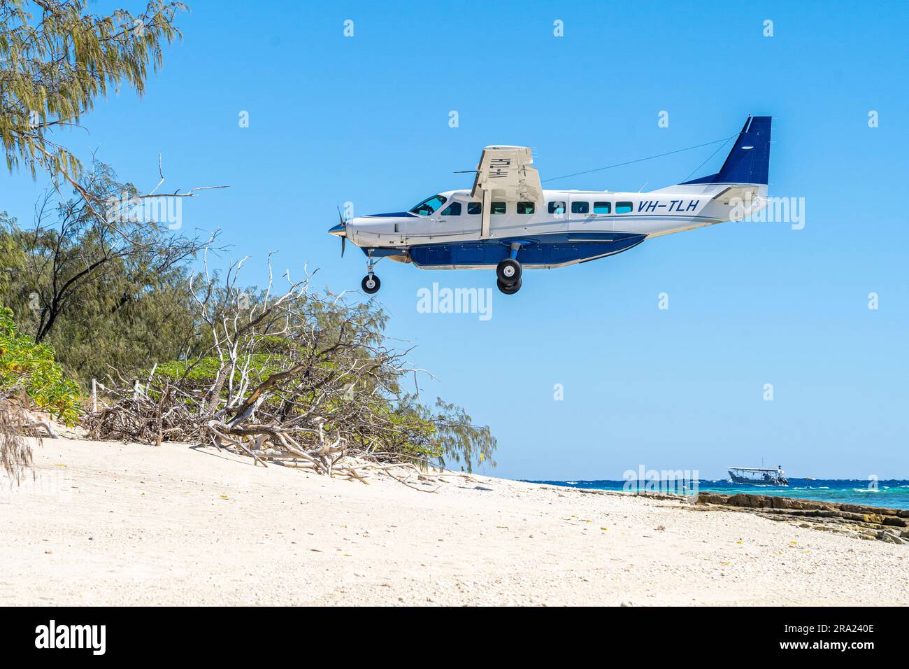 Cessna Caravan 208 Sea Air flying over beach on landing approach to ...