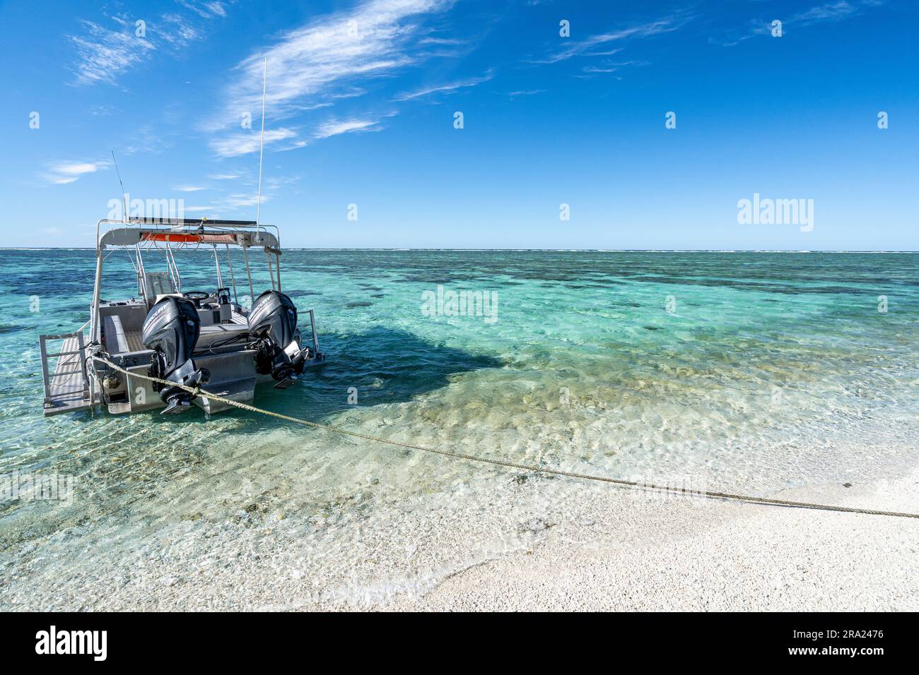 Glass-bottomed boat anchored in protected waters of Lagoon Beach, Lady ...