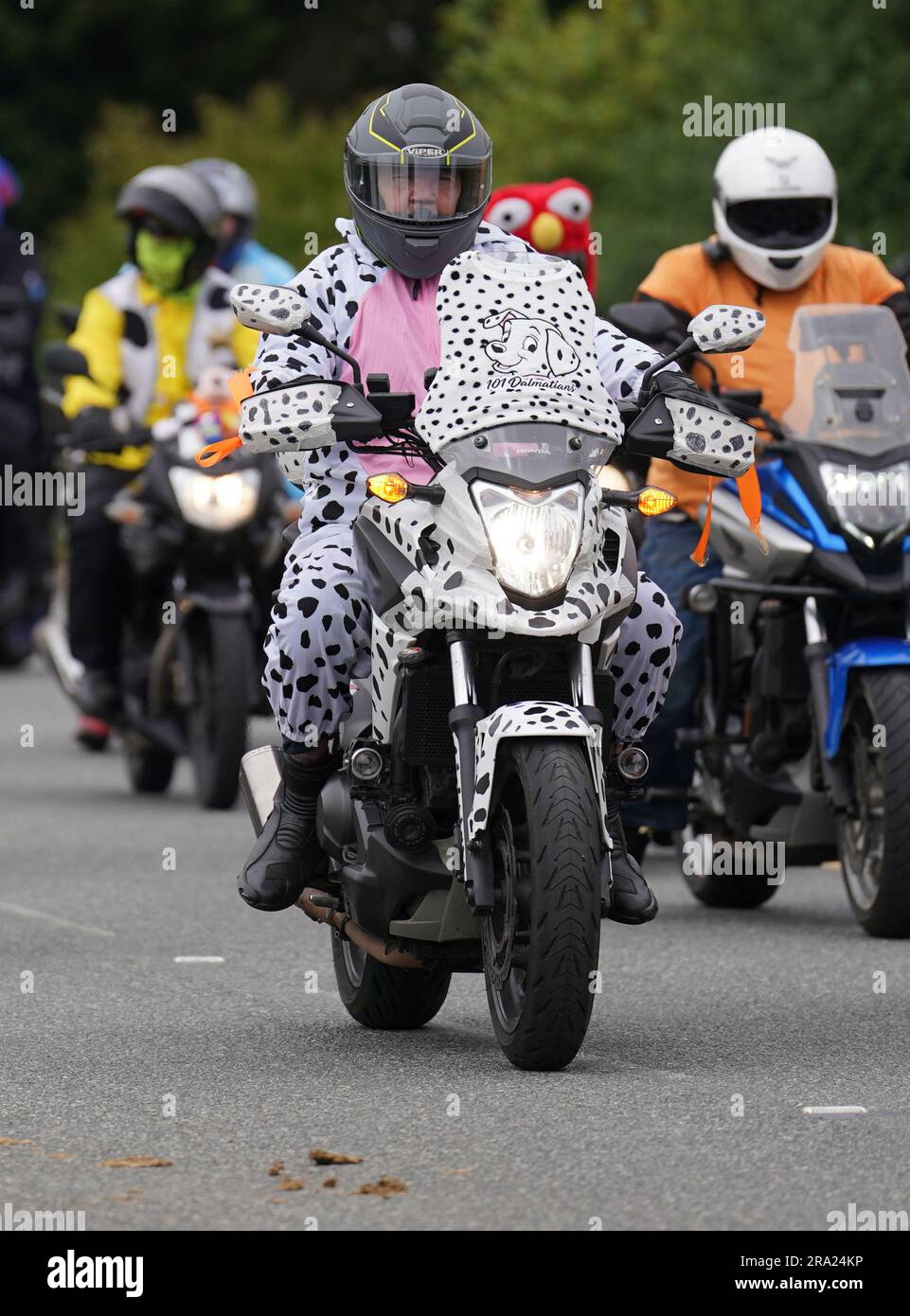 Bikers dressed in Disney costumes ride motorbikes in the Disney-themed ...