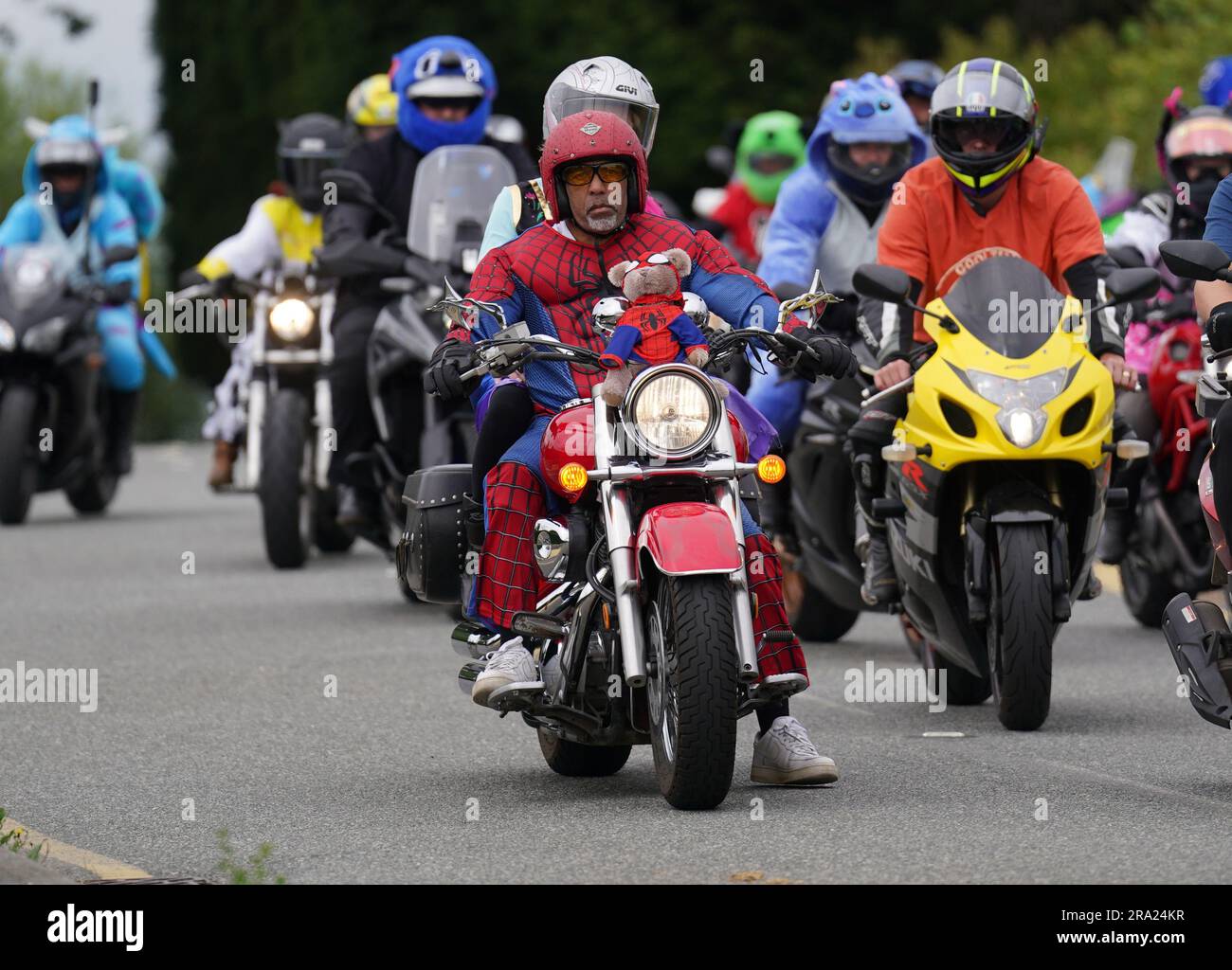 Bikers dressed in Disney costumes ride motorbikes in the Disney-themed ...