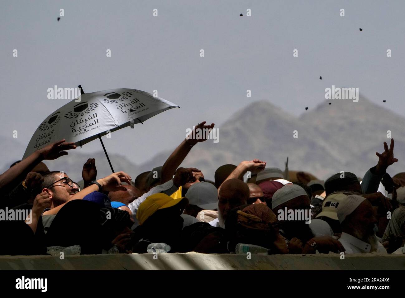 Muslim pilgrims cast stones at pillars in the symbolic stoning of the ...