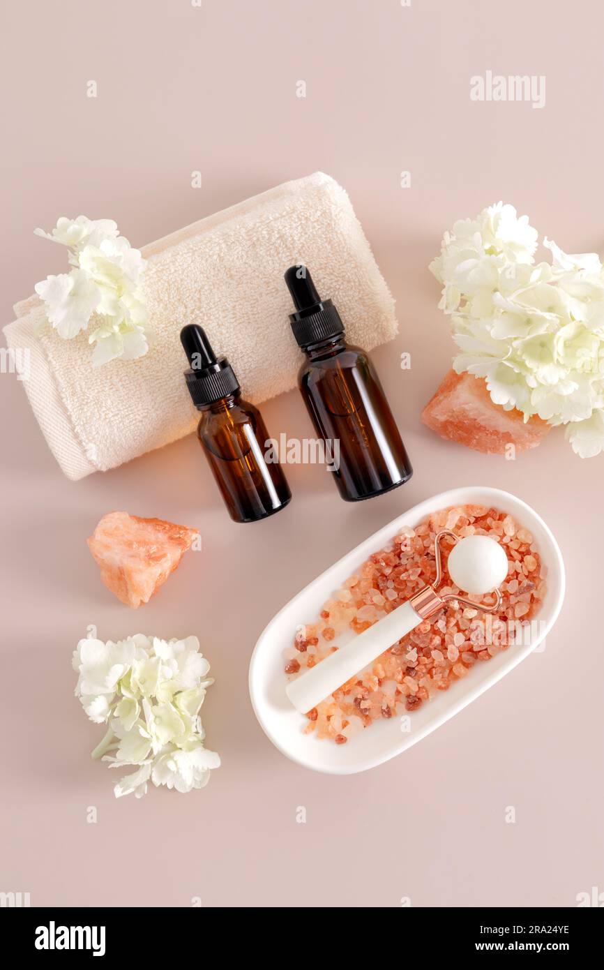 A set of cosmetics in bottles with a pipette, a white roller and bath ...