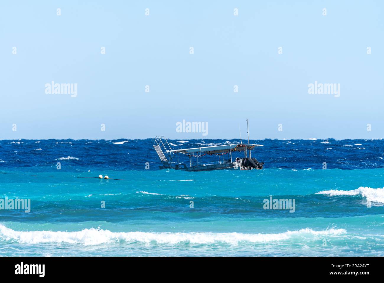 Glass bottomed boats anchored of Lighthouse Beach, Lady Elliot Island ...