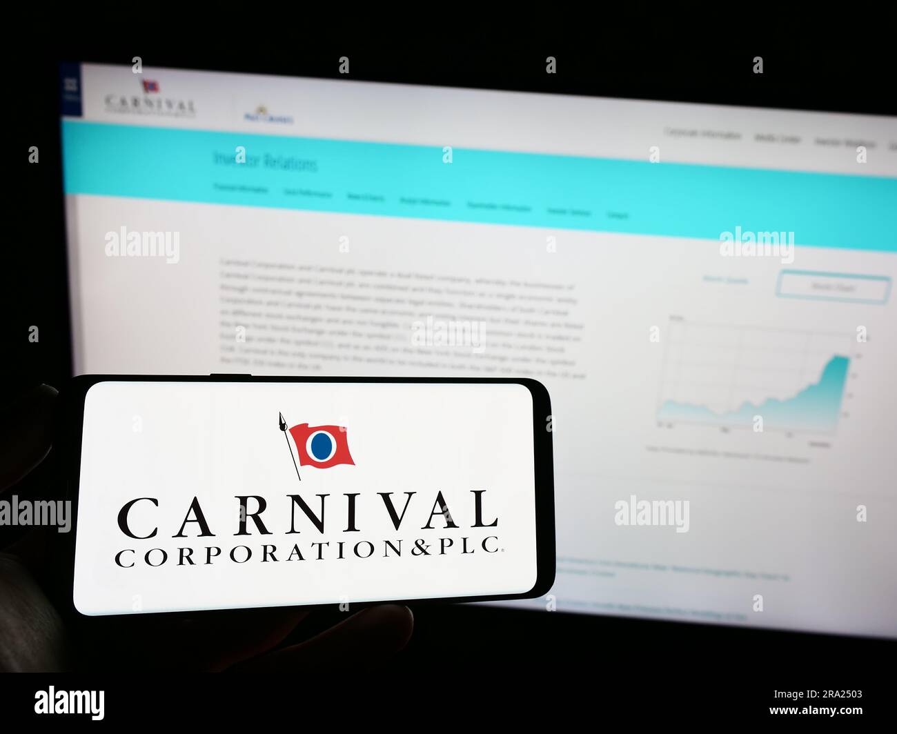 Person holding mobile phone with logo of cruise company Carnival ...
