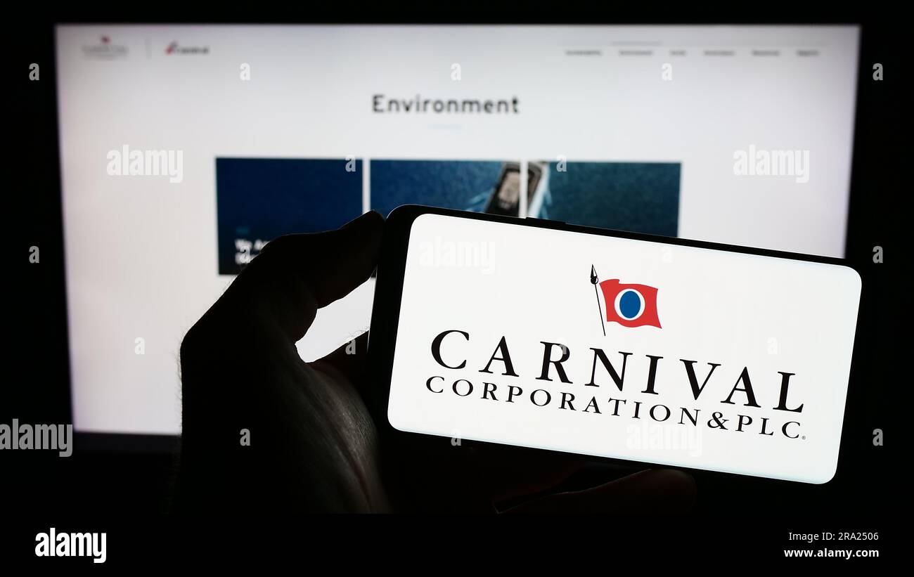Person holding cellphone with logo of cruise company Carnival ...