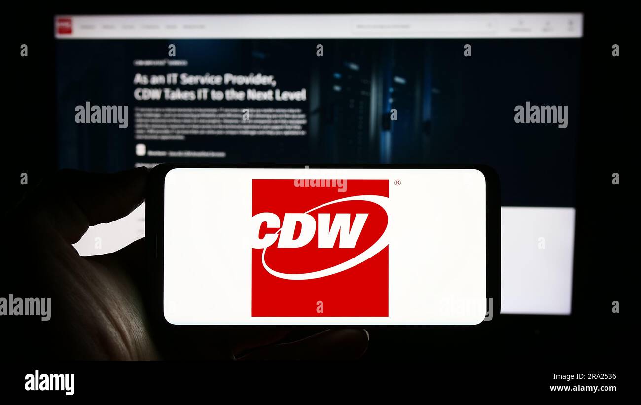 Person holding cellphone with logo of US technology company CDW ...