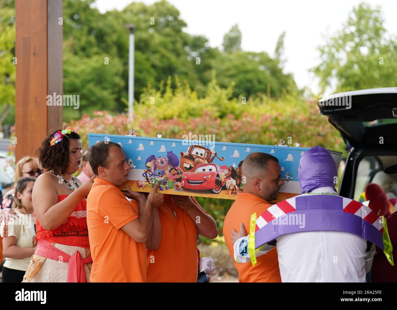 The coffin of Noah Cox-Lee, decorated with Disney cartoons is carried ...