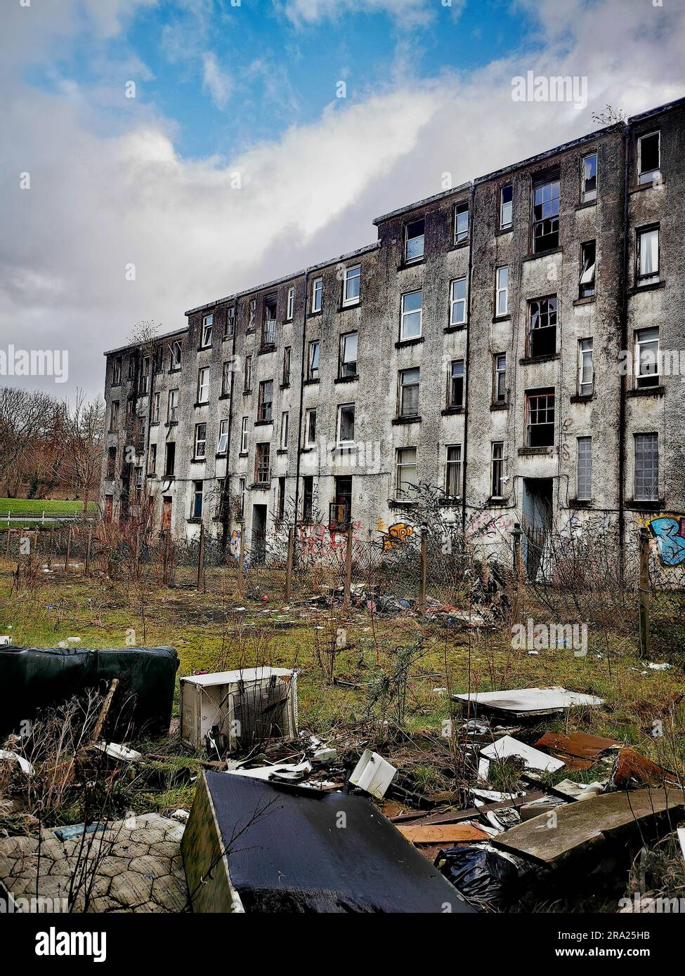 An exterior shot shows extensive fly tipping GLASGOW, SCOTLAND WELCOME ...