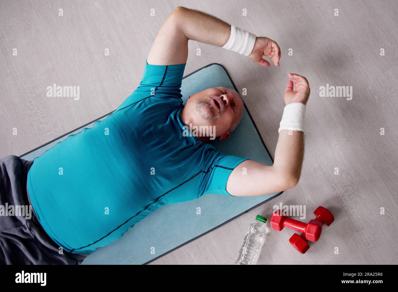 Funny Home Workout Man. Tired After Fun Gym Exercise Stock Photo - Alamy