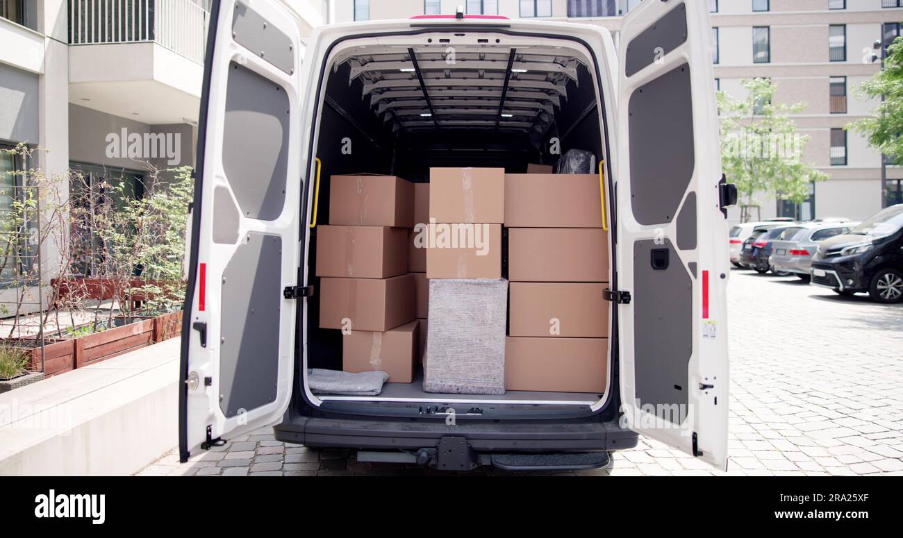 House Removal Truck With Boxes And Furniture Stock Photo - Alamy