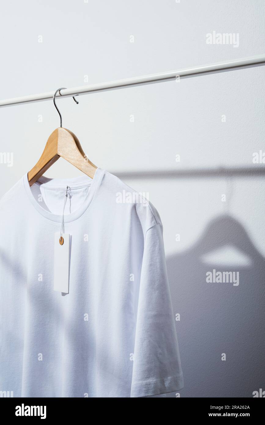 Blank White t-shirt mockup, template on wooden hanger displayed on a ...