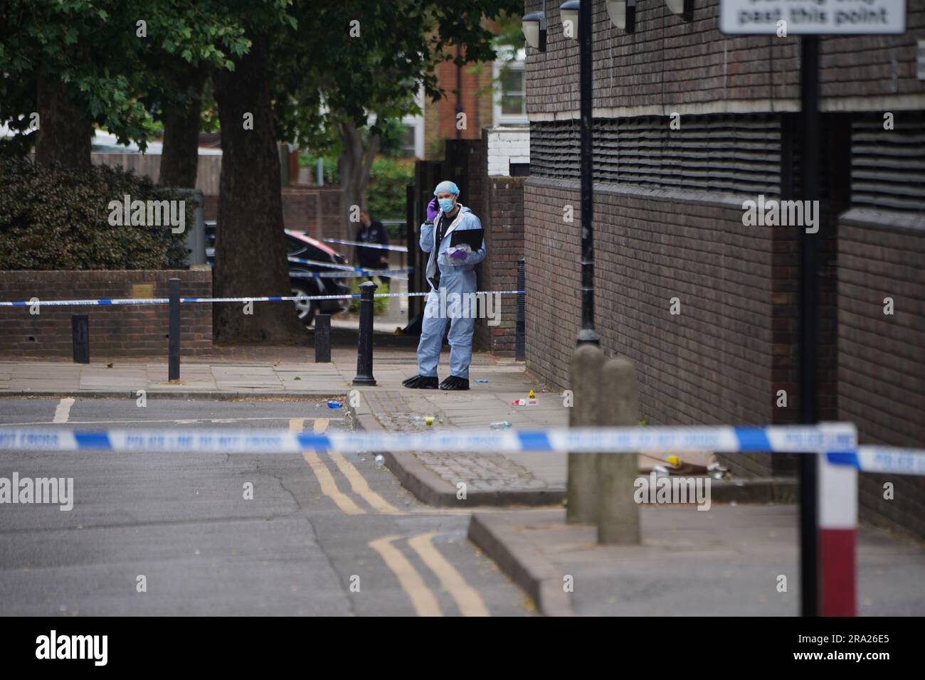 Forensic officers in Elthorne Road, Islington, London after a man and a ...