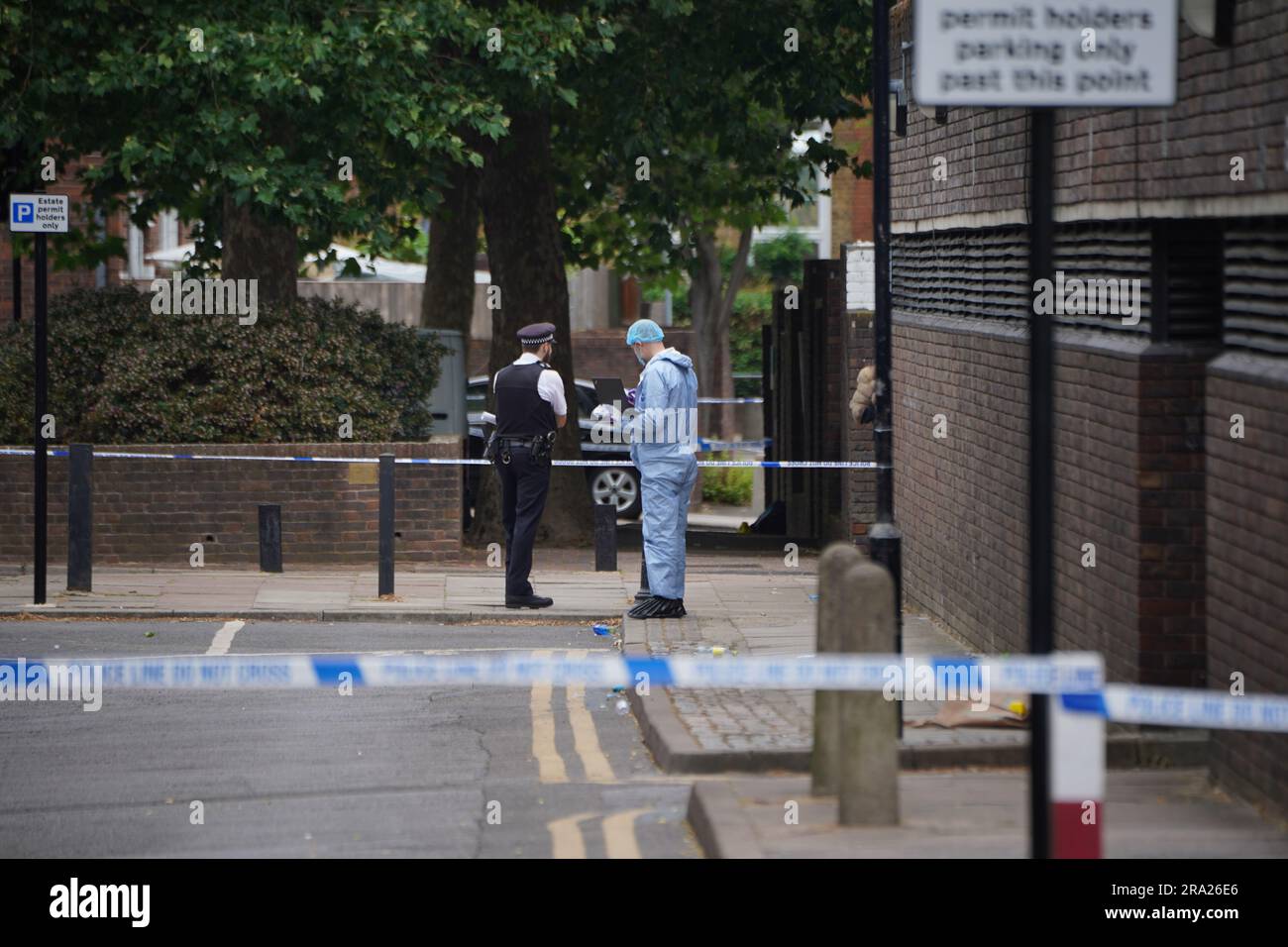 Forensic officers in Elthorne Road, Islington, London after a man and a ...