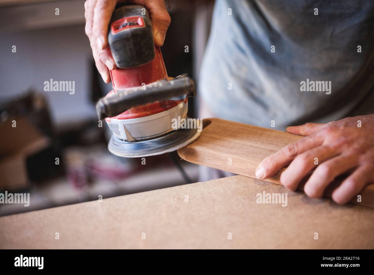 Detail of a craftsman's hands using a sander Stock Photo - Alamy