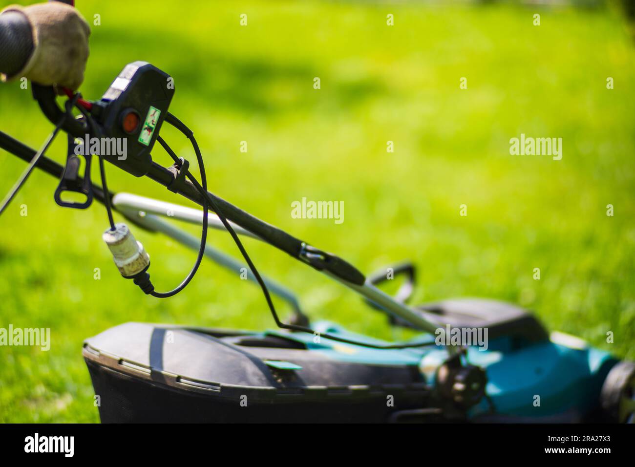 Lawn mover on green grass in modern garden or backyard. Machine for ...