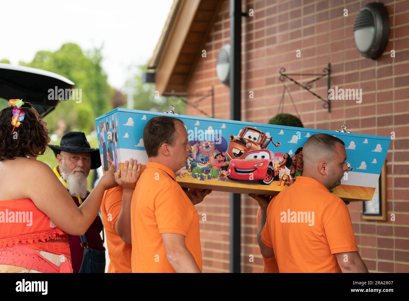 The coffin of Noah Cox-Lee, decorated with Disney cartoons is carried ...
