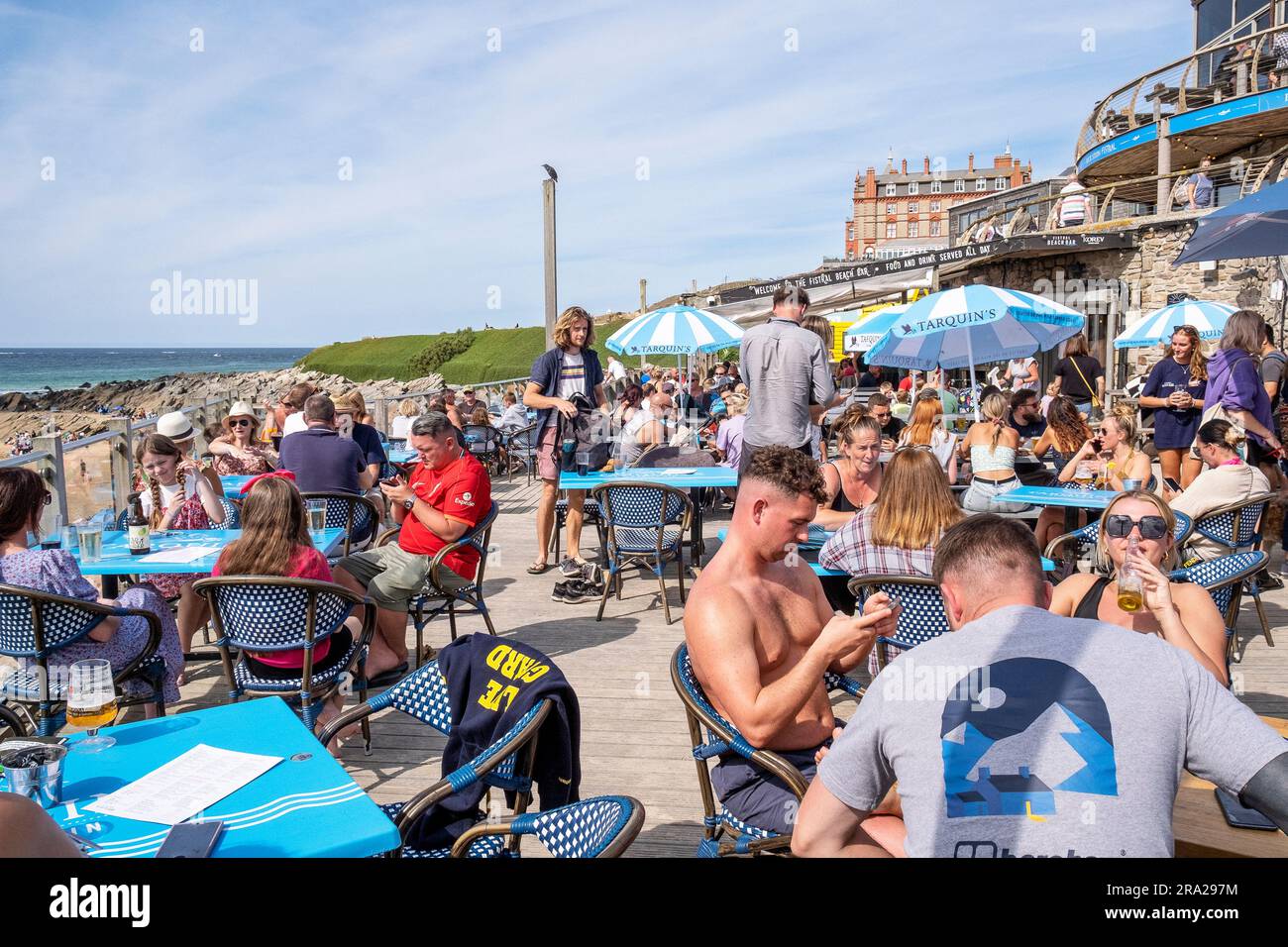 Holidaymakers relaxing on the outdoor seating area of the popular ...