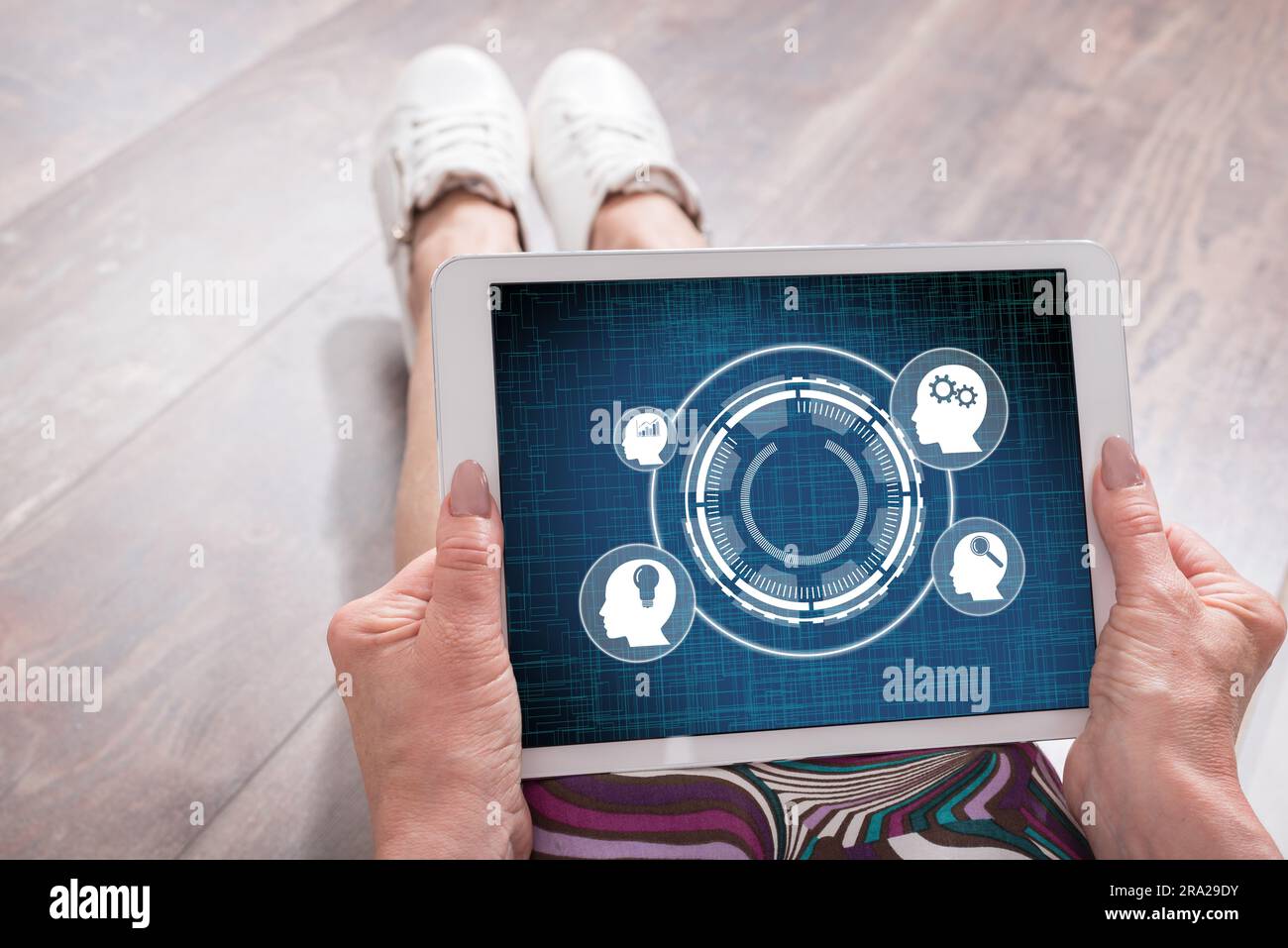 Woman sitting on the floor with a tablet showing process improvement ...