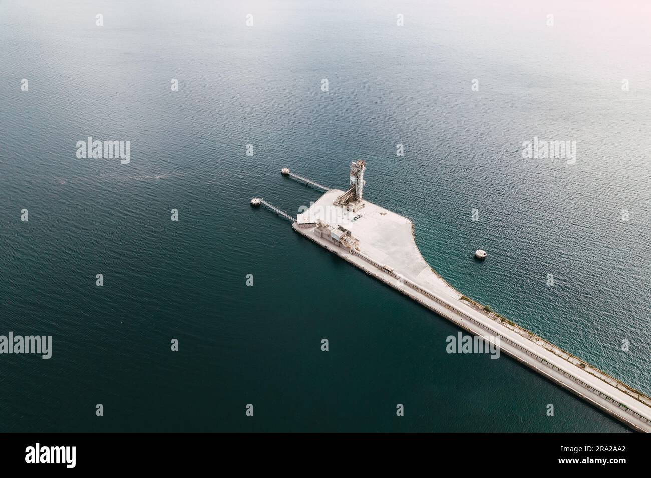 An aerial view of a picturesque coastal port and pier surrounded by ...