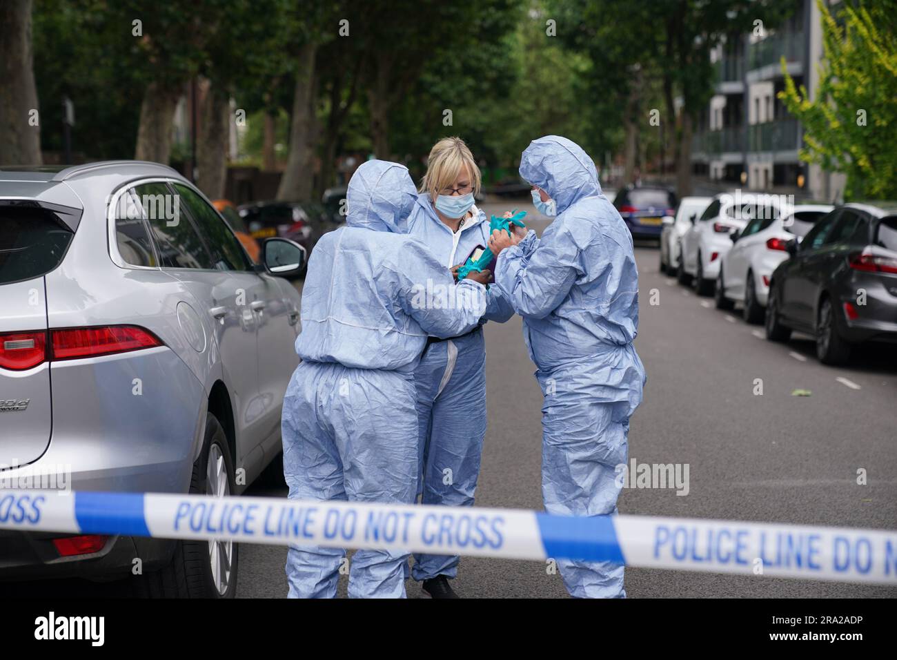 Forensic officers in Elthorne Road, Islington, London after a man and a ...