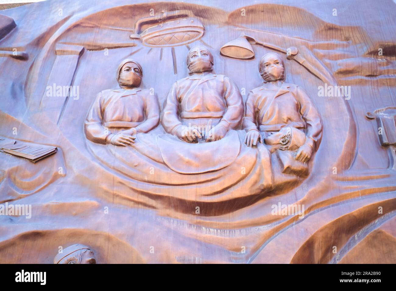Three medical doctors, nurses in an operating room at a hospital with ...