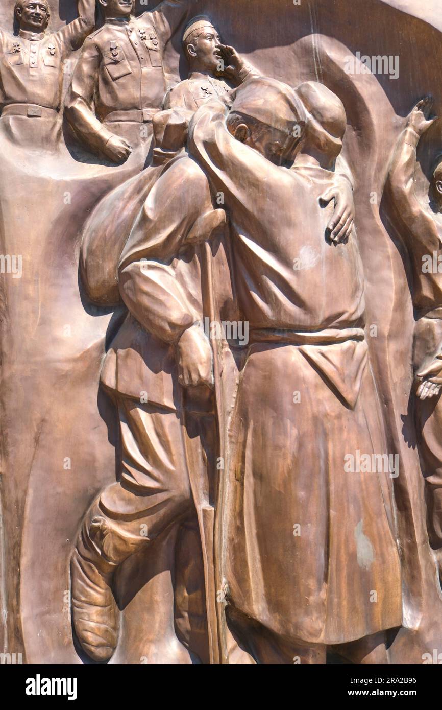 A wounded soldier hugs his father. Detail of the front entrance bronze frieze. At the Shon ...