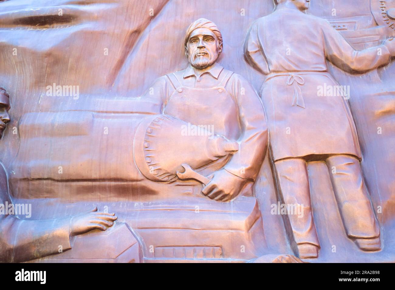 A factory worker building a weapon. Detail of the front entrance bronze frieze. At the Shon ...