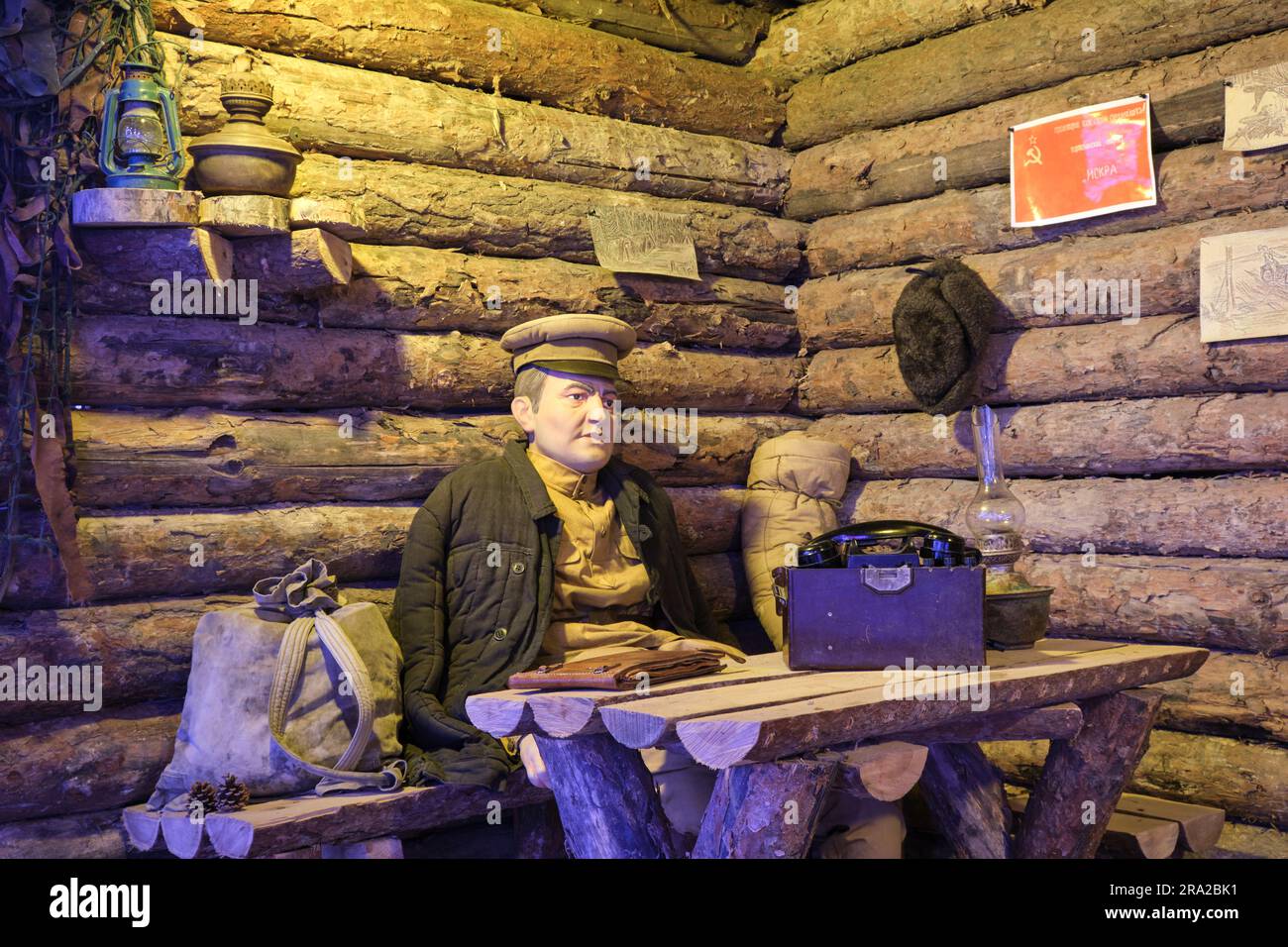 A diorama of a soldier sitting in a log bunker, shelter. With portable ...