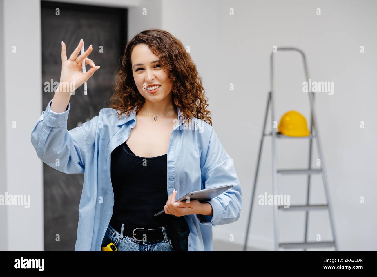 Young attractive woman in casual clothes with tablet, studying ...