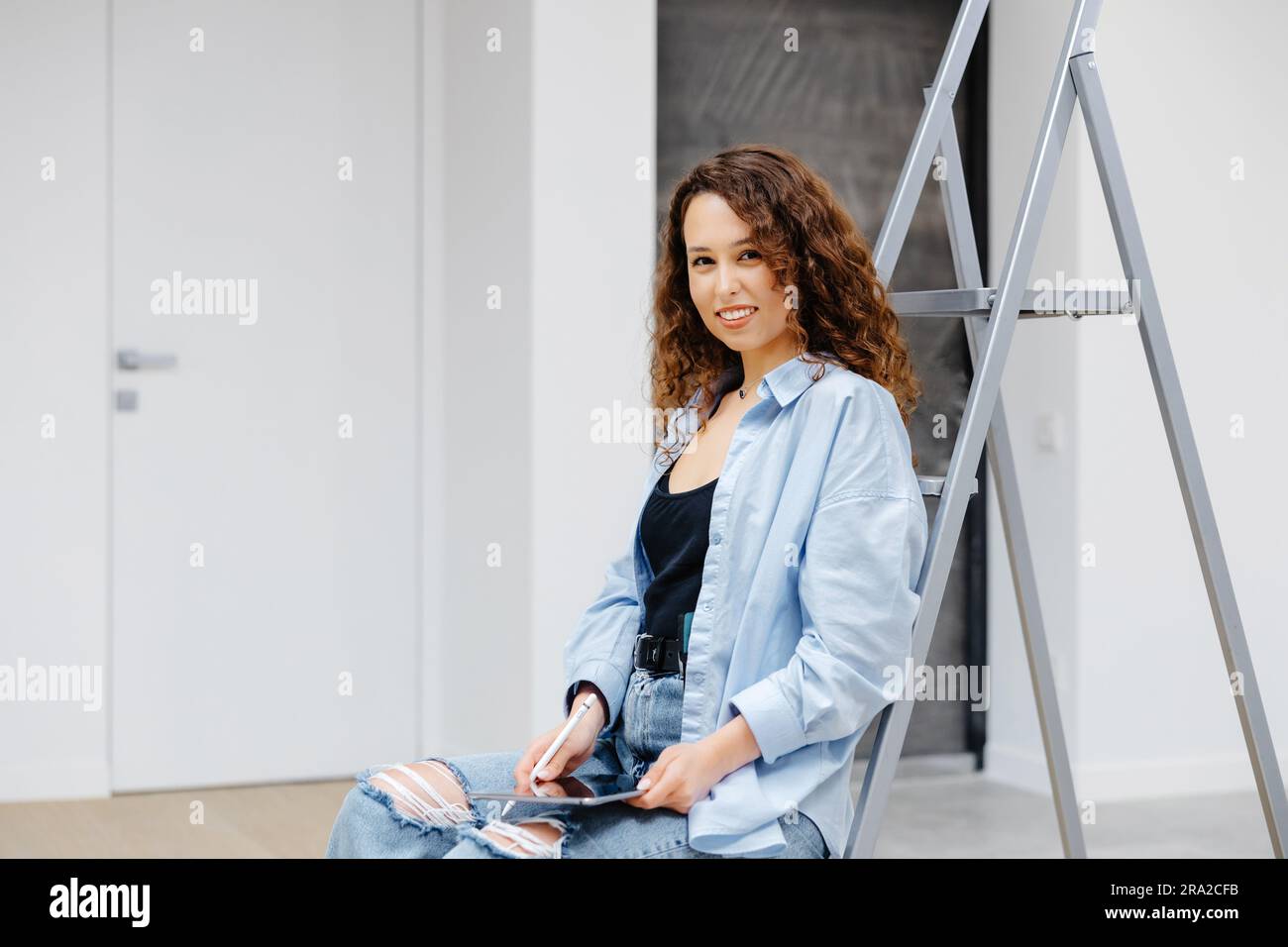 Young attractive woman in casual clothes with tablet, studying ...