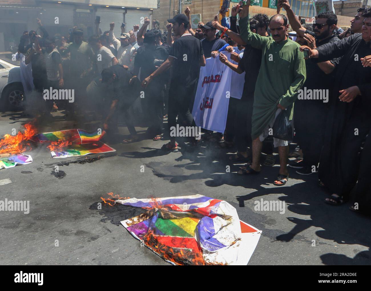Supporters of Shiite Muslim leader Moqtada Sadr burn a rainbow flag, in ...