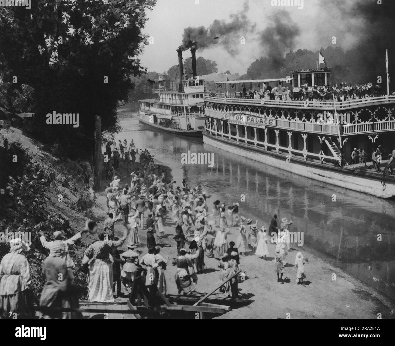 Cotton Palace Showboat being pushed up a canal by another boat While ...