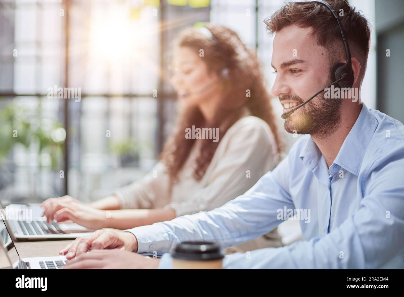 Customer Service Representative With Colleague Working In Office Stock ...