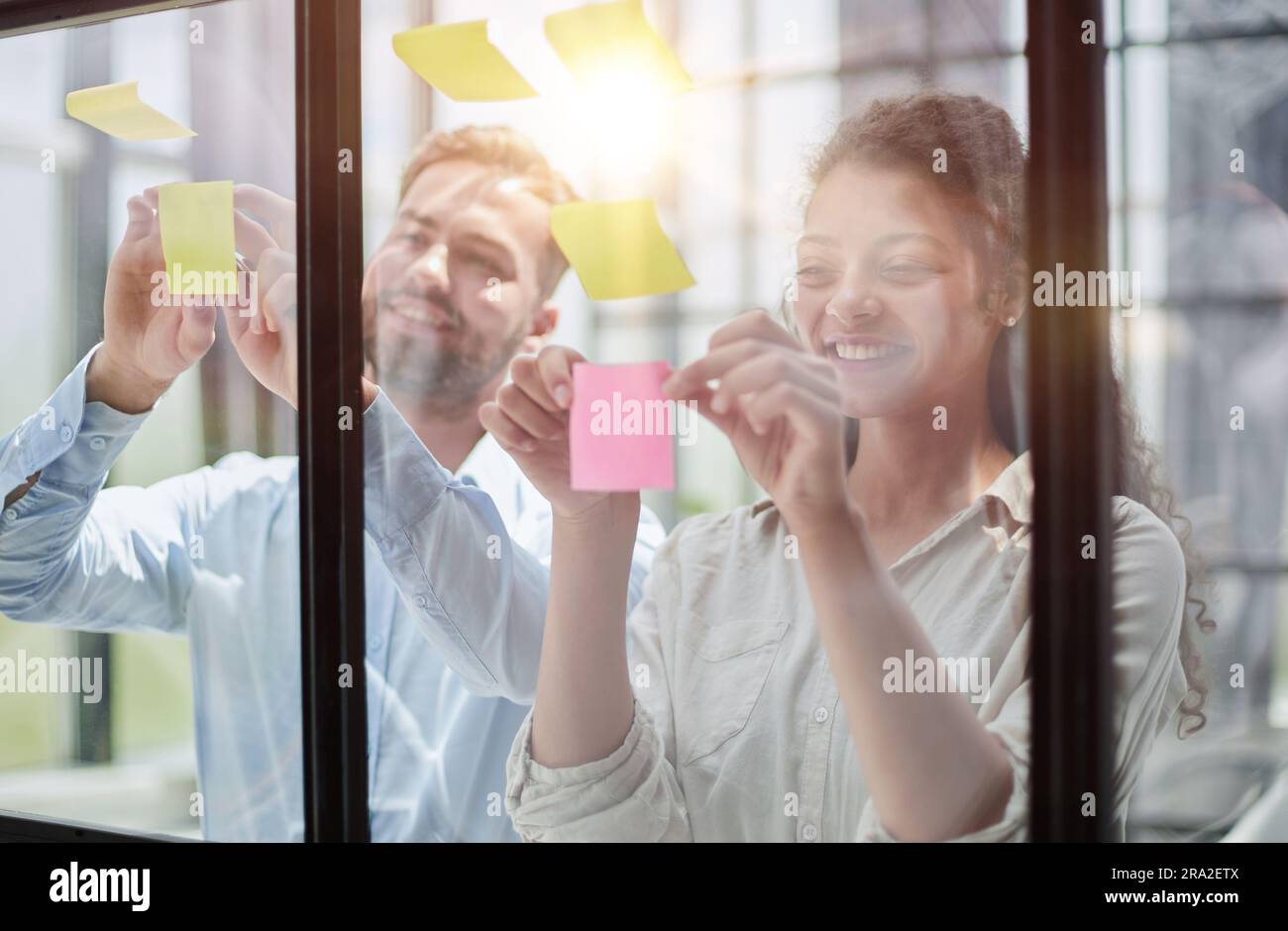 Group pointing at wall behind hi-res stock photography and images - Alamy