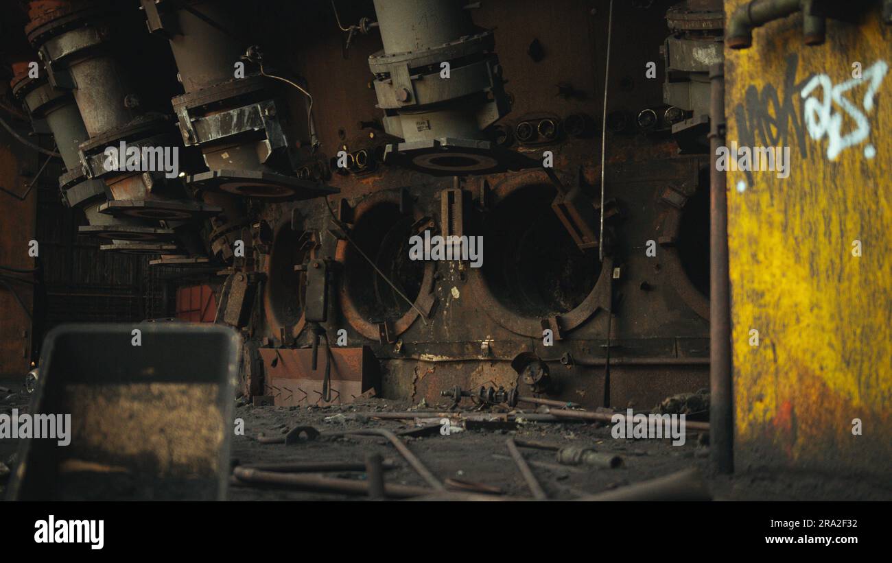 An interior view of an abandoned factory, featuring an array of broken ...