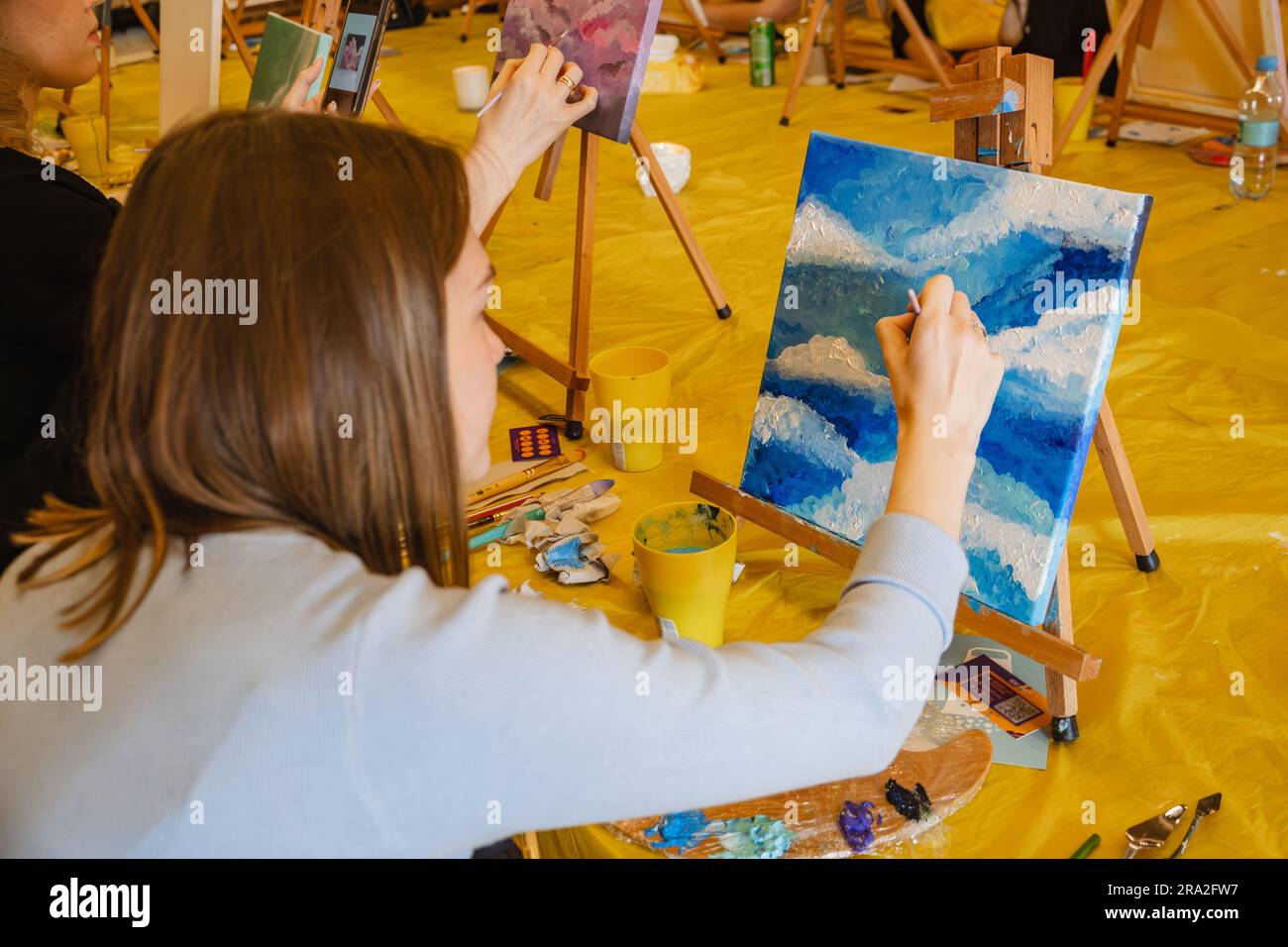 Woman paint brush canvas friends hi-res stock photography and images ...