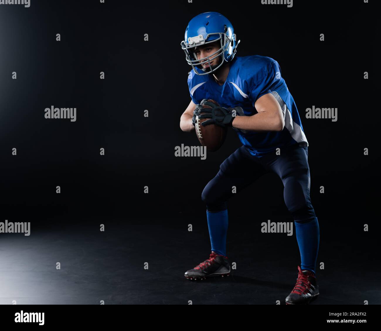 Full length portrait of a man in a blue american football uniform ...