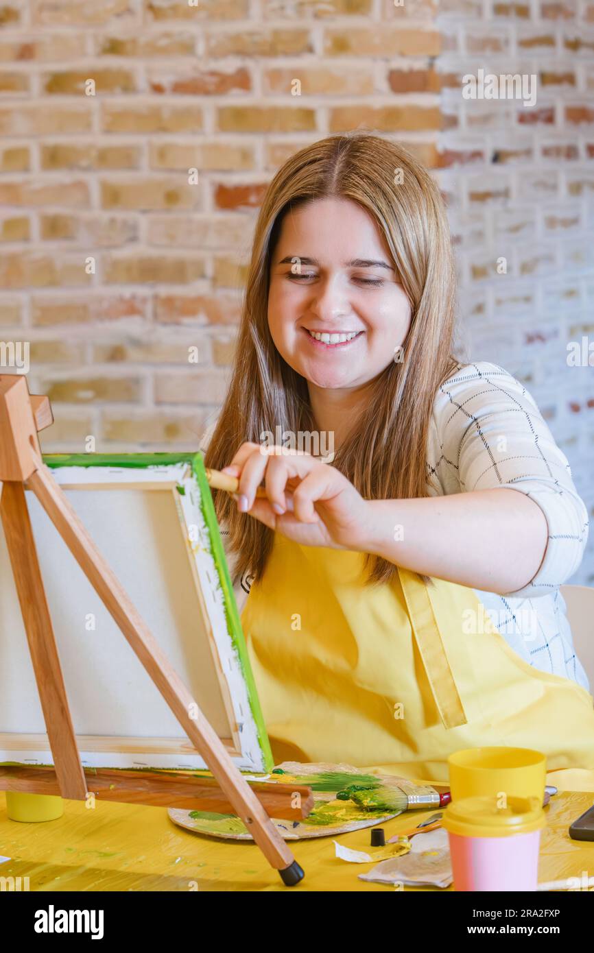 Woman paint brush canvas friends hi-res stock photography and images ...